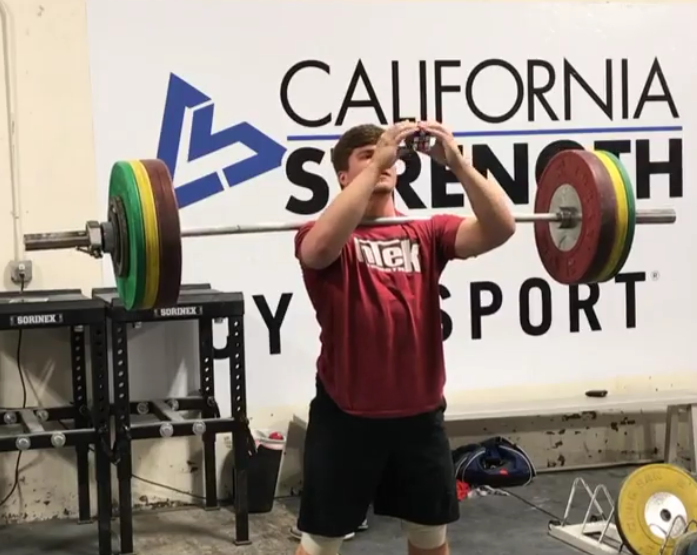 Dylan Cooper Clean & Jerks 300 lbs While Solving a Rubik's Cube | BarBend
